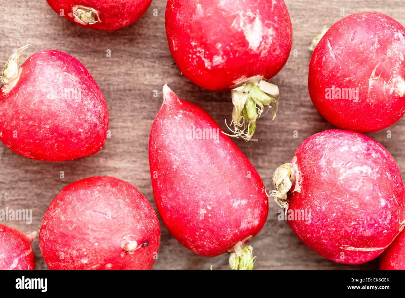 Fresh raw radishes on a wooden surface Stock Photo - Alamy