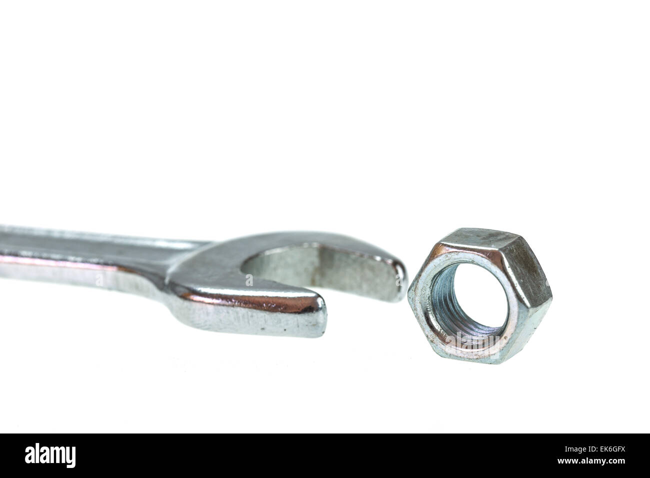 Wrench with nut isolated on white background Stock Photo - Alamy