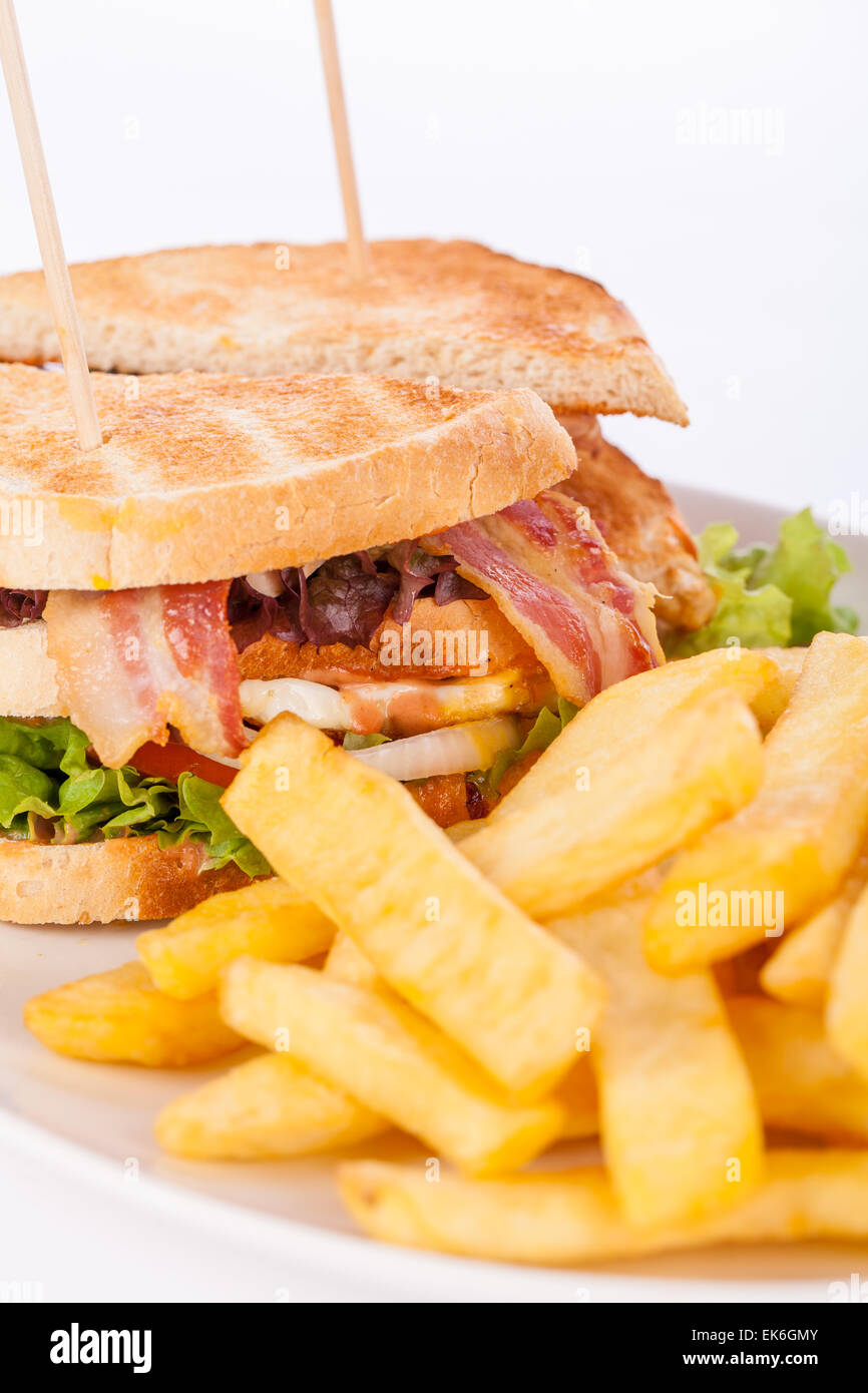 Club sandwich on toasted white bread with a meat filling served with ...