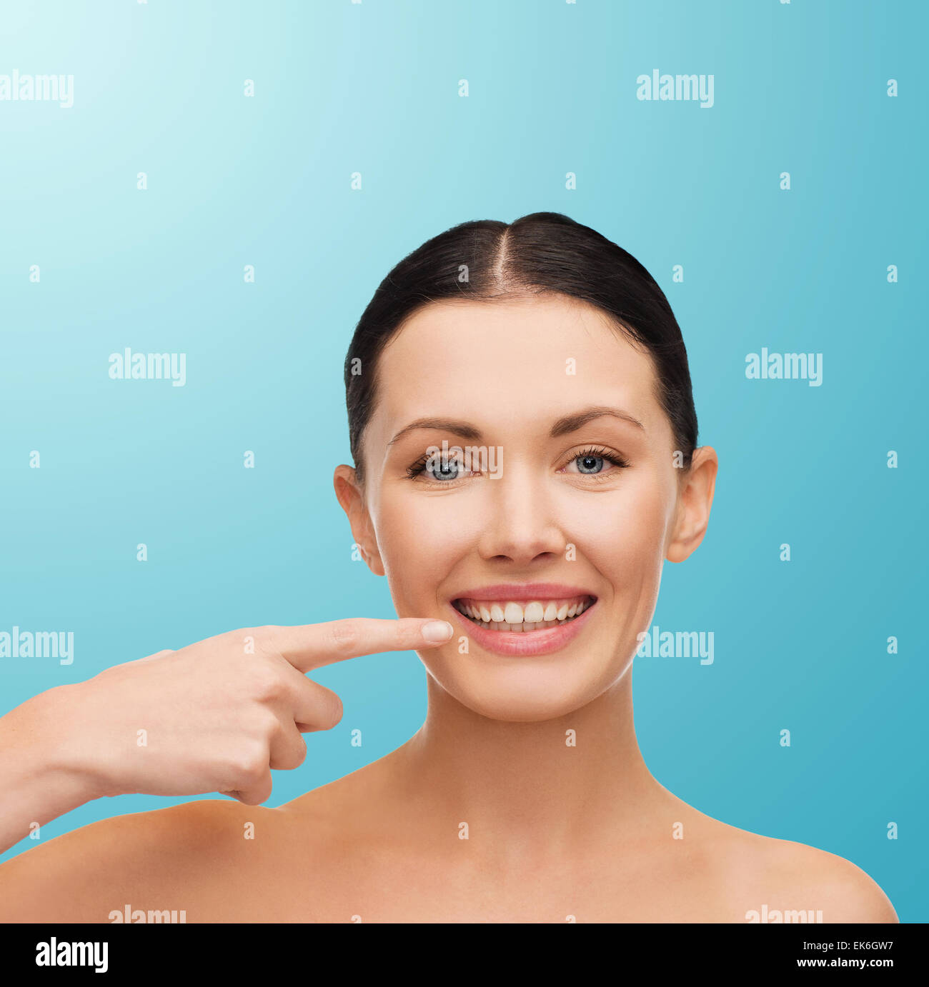young calm woman pointing to her mouth Stock Photo - Alamy