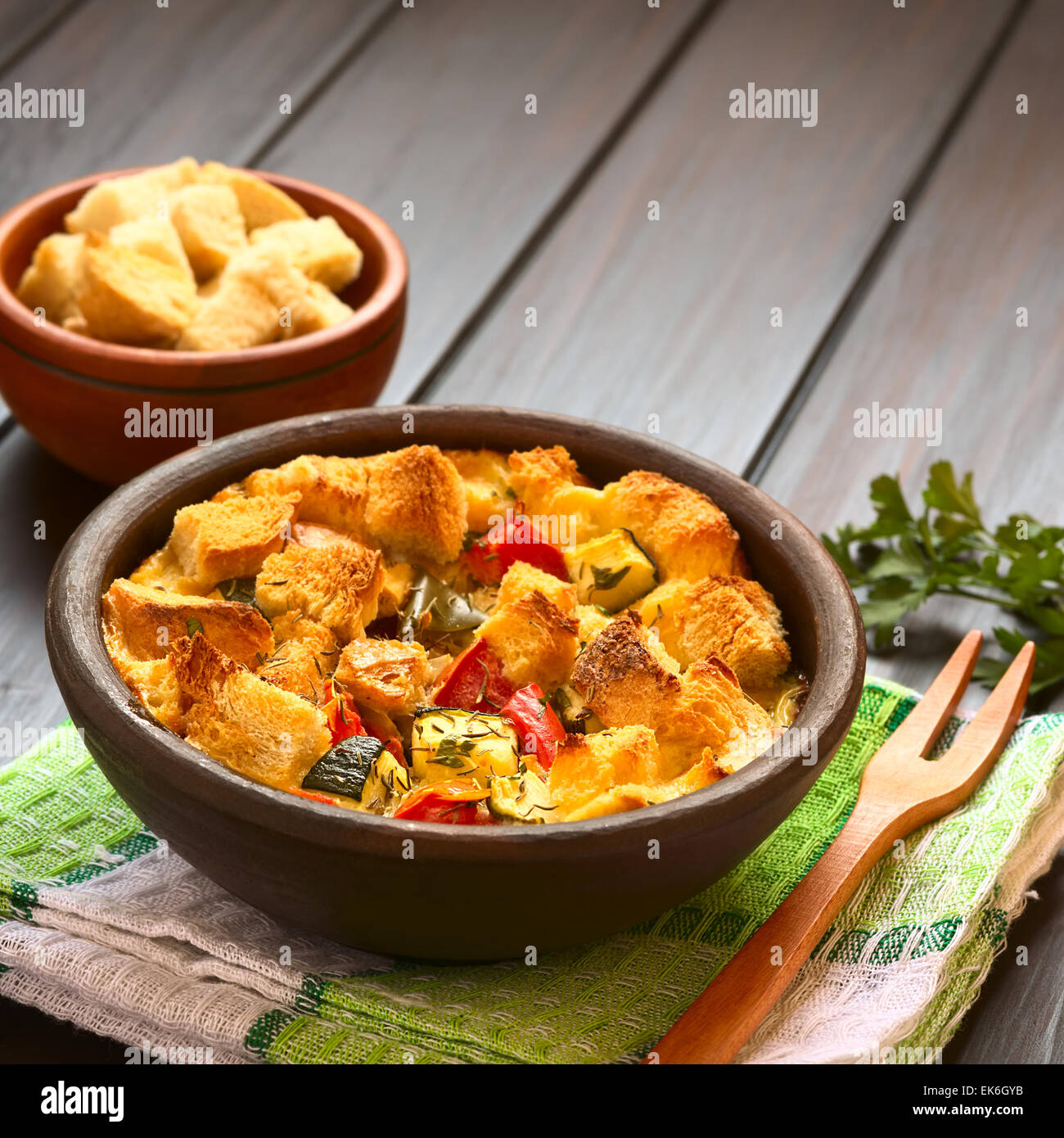 Savory baked vegetarian bread pudding made of zucchini, bell pepper ...