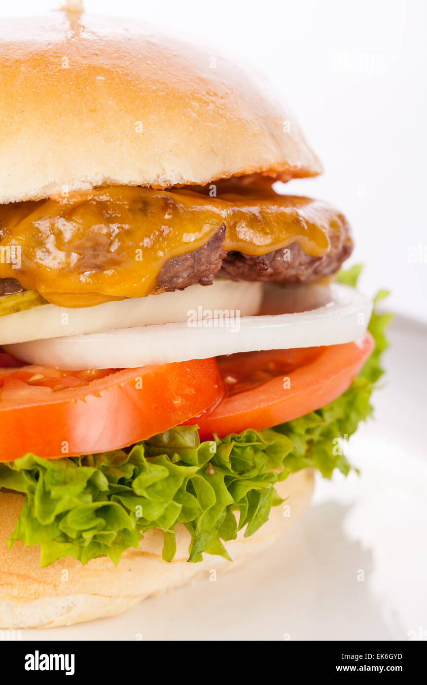 Tasty traditional cheeseburger with a ground beef patty topped with ...