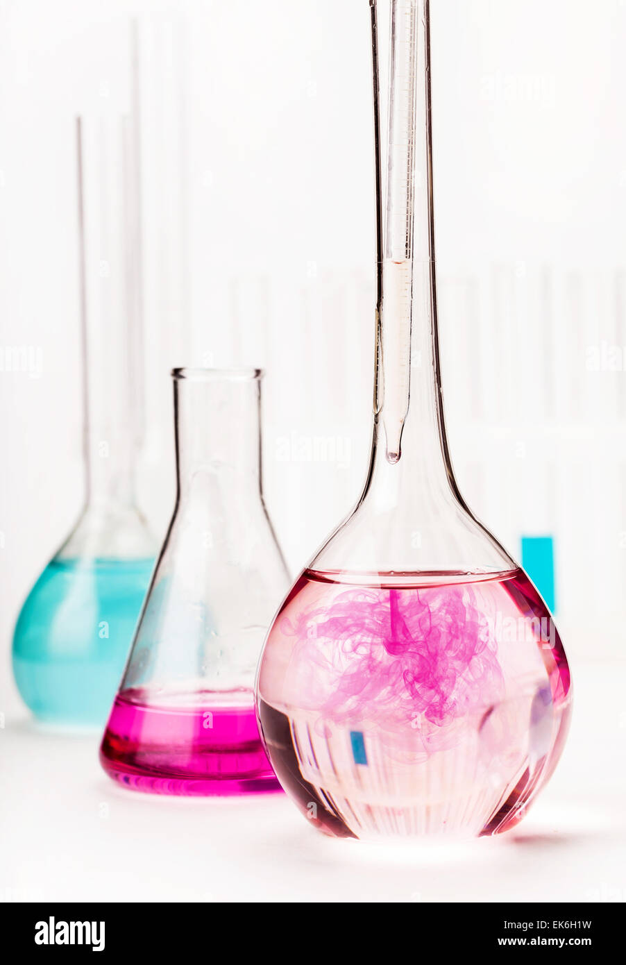 various flasks with reagents on white background Stock Photo - Alamy