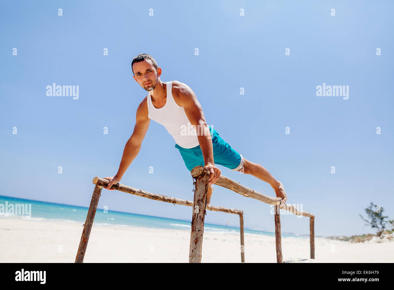 fitness handsome man work out on the beach with sea view Stock Photo ...