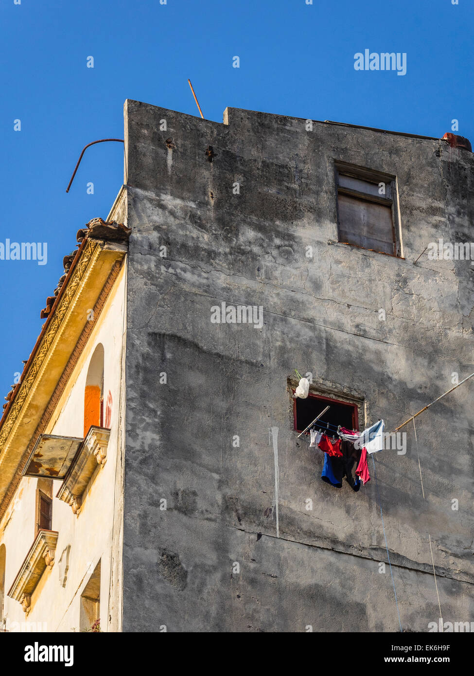 The wash dries in a third story window of an old apartment building in ...