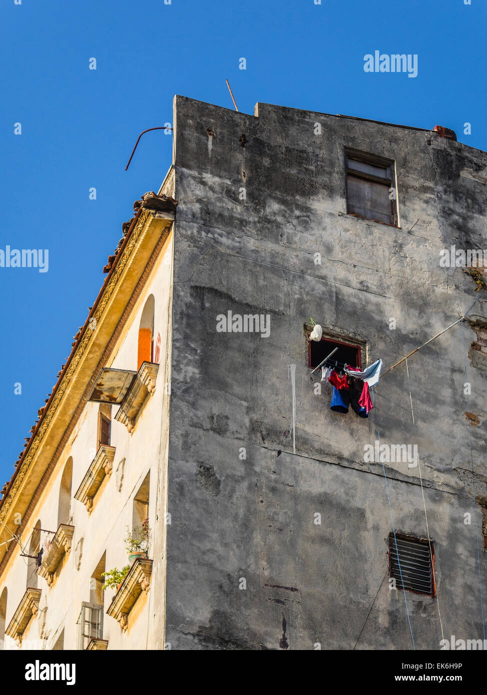 The wash dries in a third story window of an old apartment building in ...