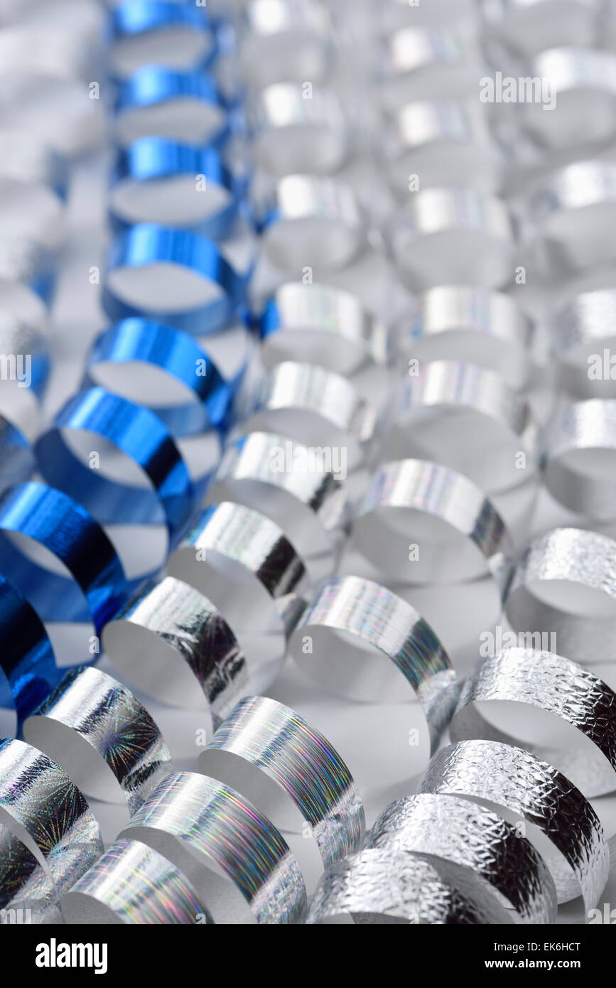 Coiled gift wrap ribbons in silver and blue for a celebration party ...