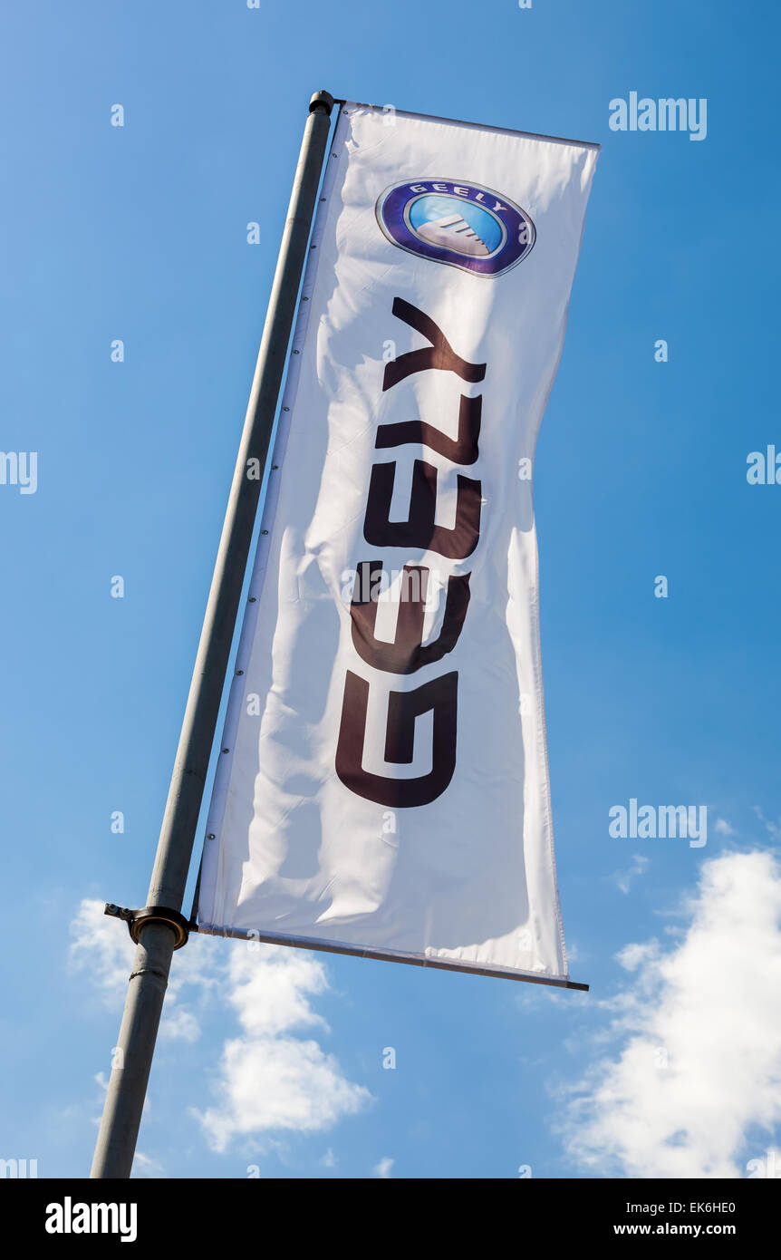 The flag of Geely over blue sky. Geely is a Chinese automotive ...