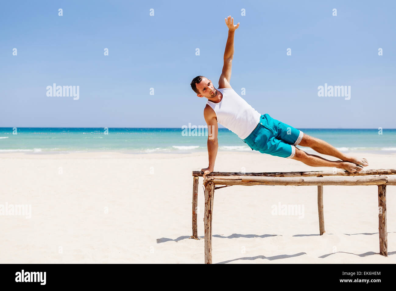 fitness handsome man work out on the beach with sea view Stock Photo ...