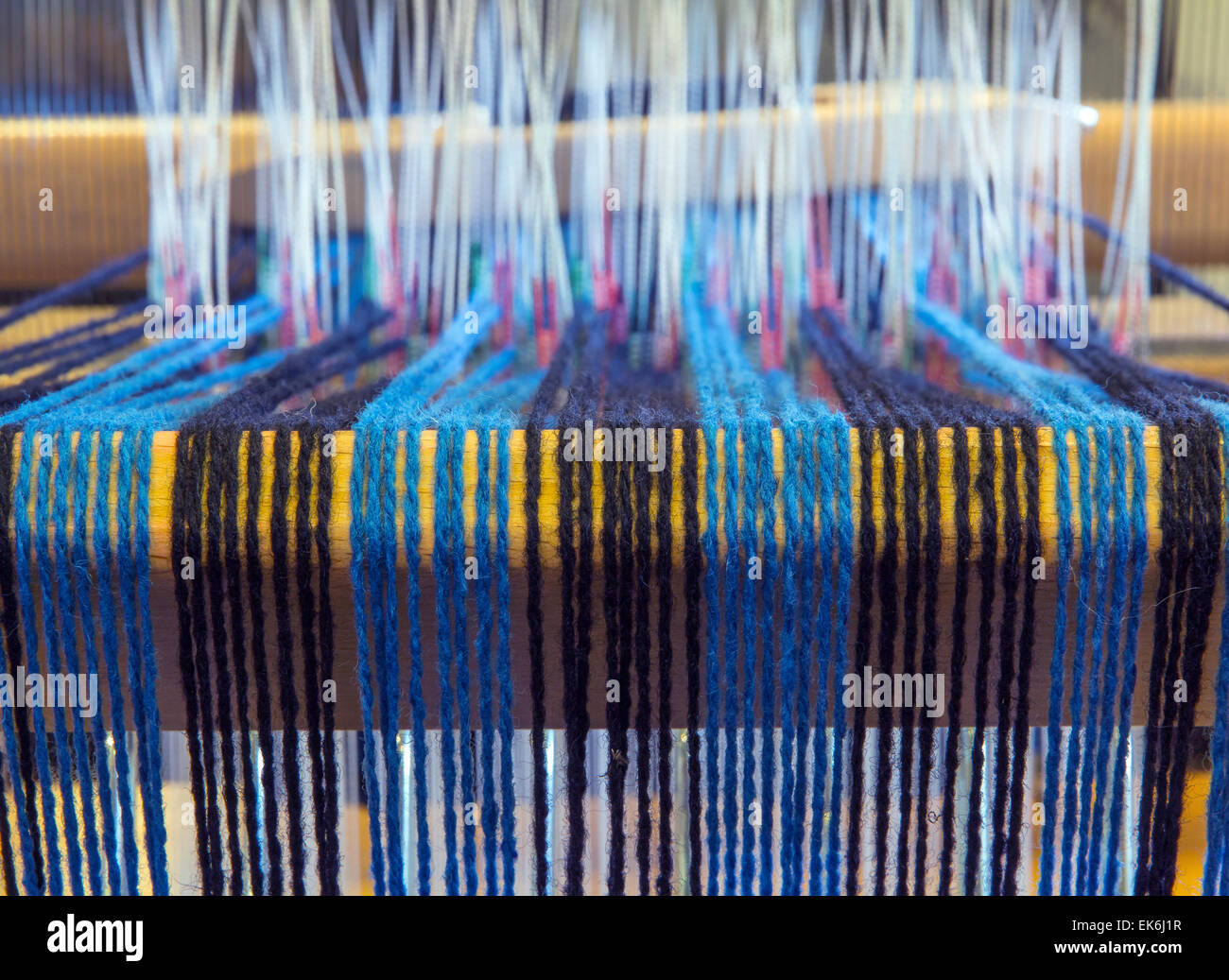 Turquoise and black warp threads at the back of a floor loom Stock ...