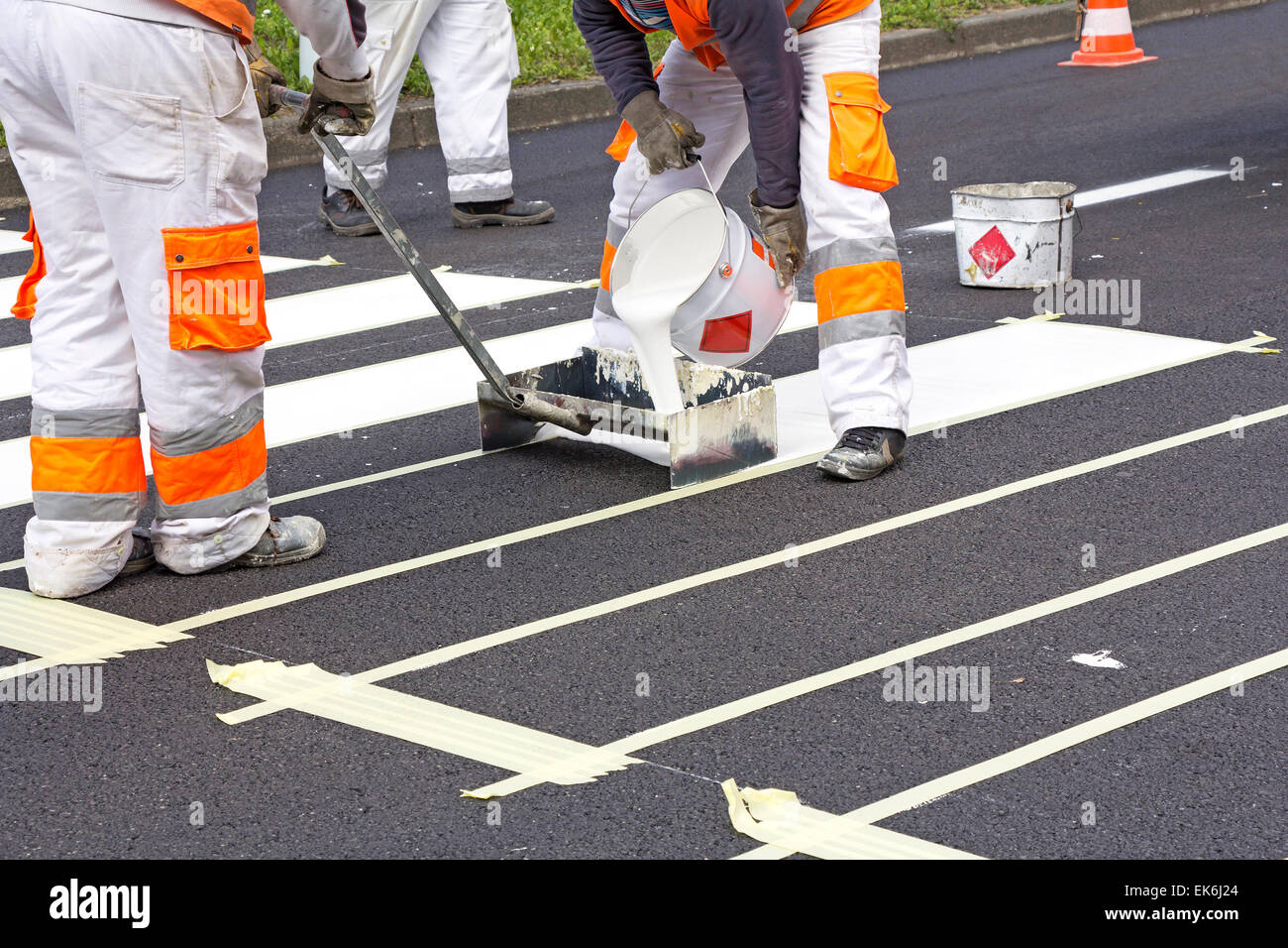 Two workers making of a new pedestrian crossing on the road Stock Photo ...
