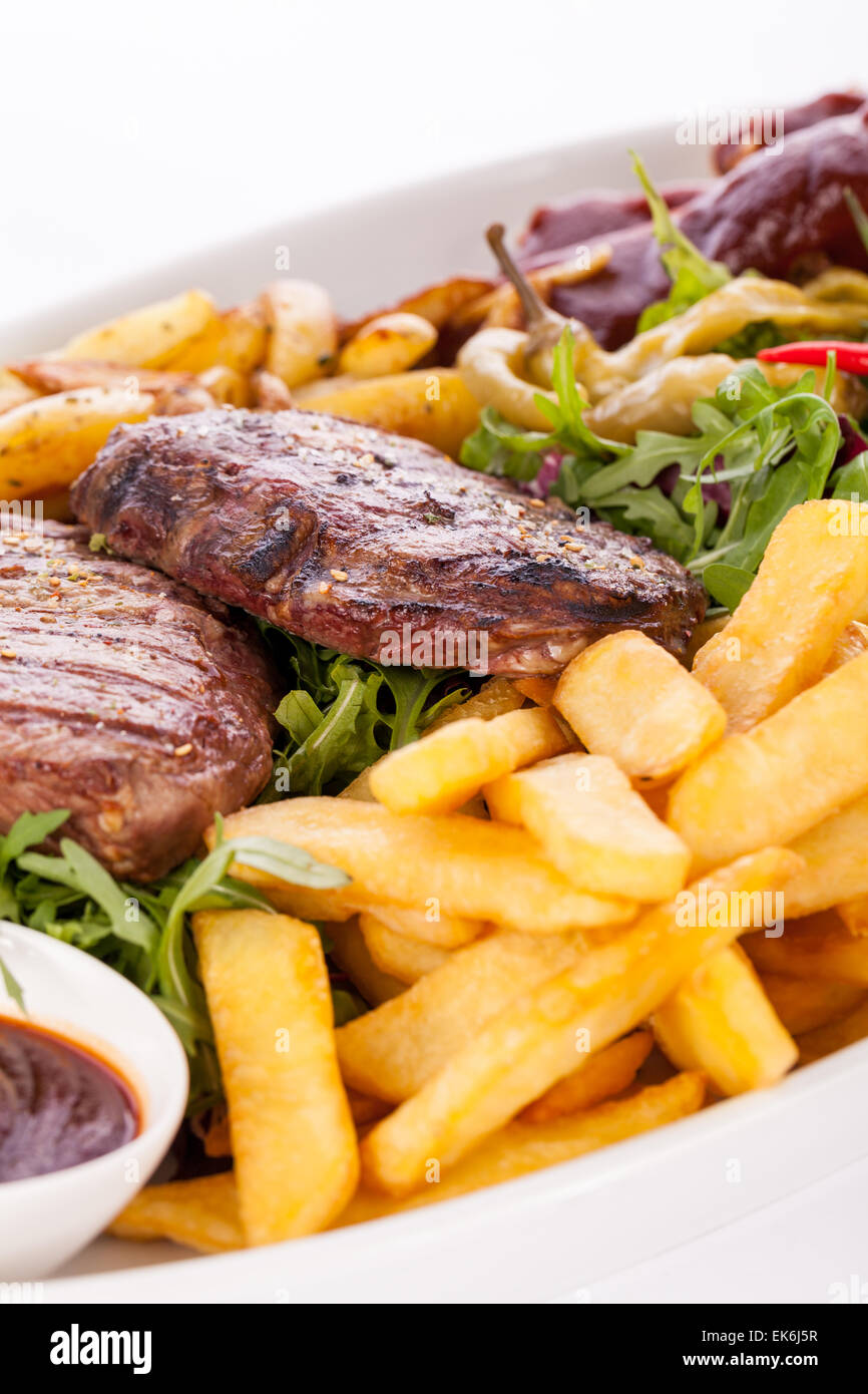 Wholesome platter of mixed meats including grilled steak, crispy ...