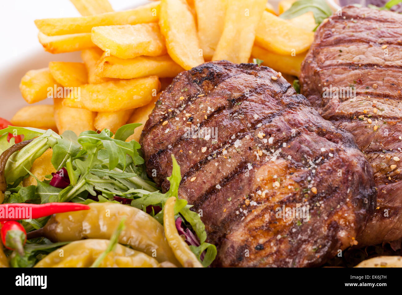 Wholesome platter of mixed meats including grilled steak, crispy ...