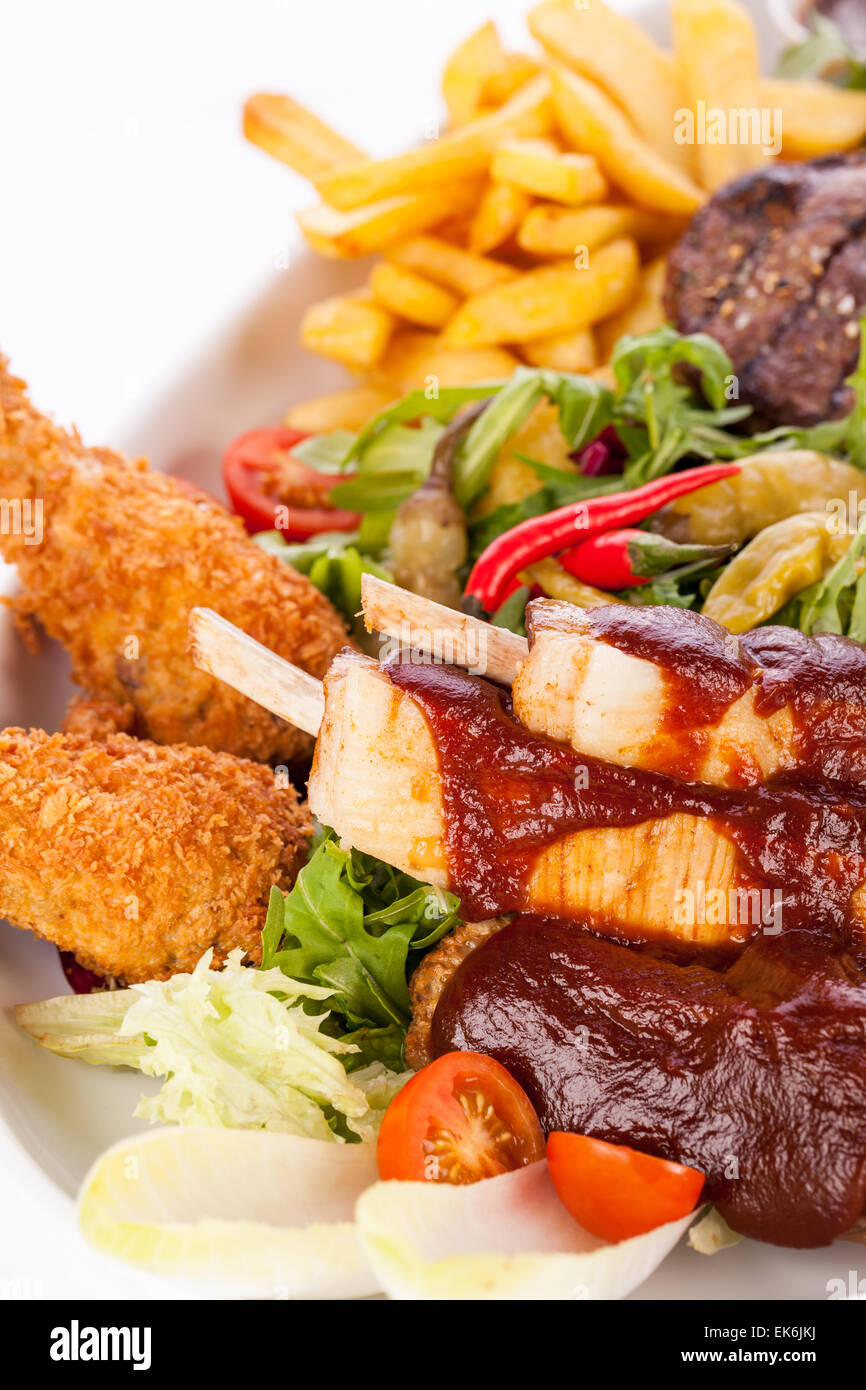 Wholesome platter of mixed meats including grilled steak, crispy ...