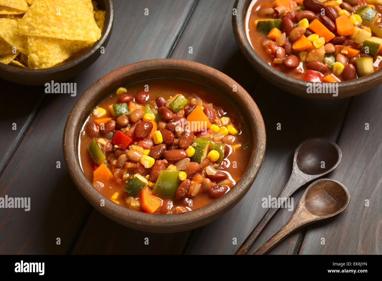 Two rustic bowls of vegetarian chili dish made with kidney bean, carrot ...