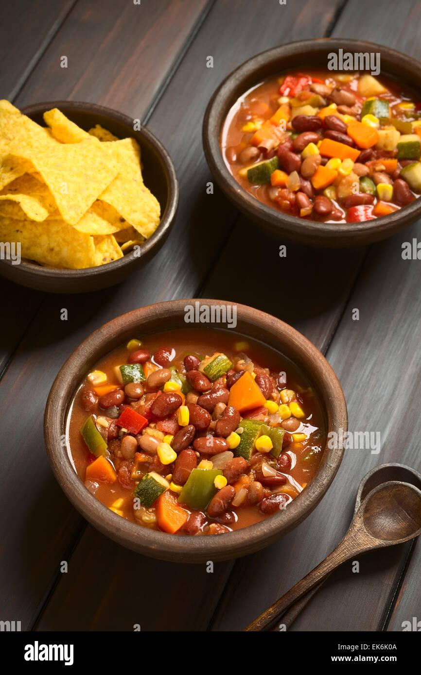 Two rustic bowls of vegetarian chili dish made with kidney bean, carrot ...