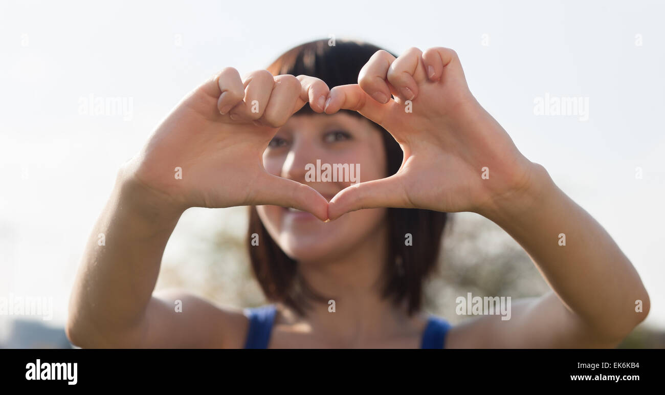 Beautiful girl show love sign Stock Photo - Alamy