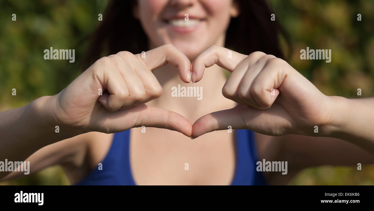 Beautiful girl show love sign Stock Photo - Alamy