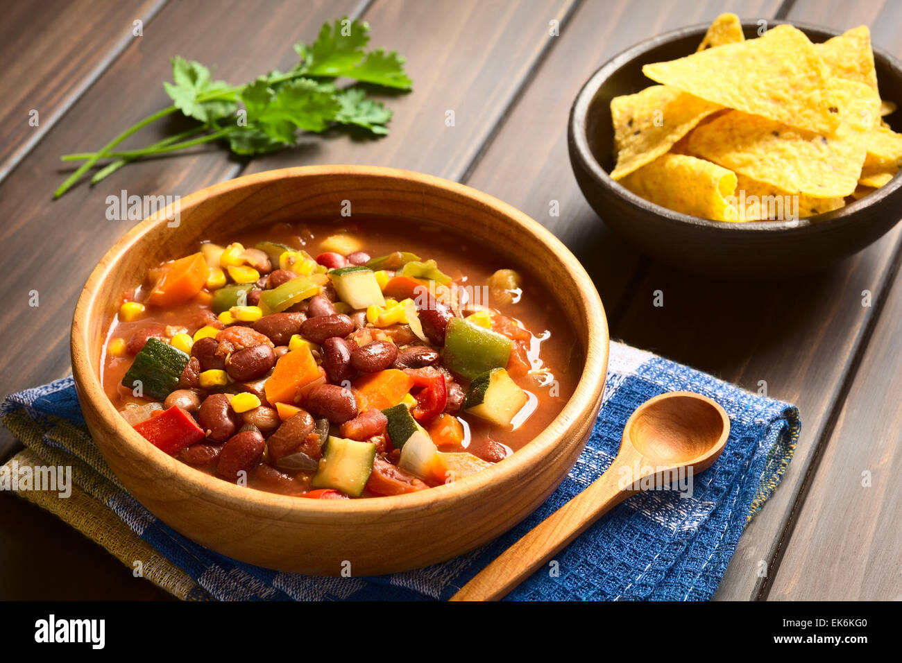 Wooden bowl of vegetarian chili dish made with kidney bean, carrot ...