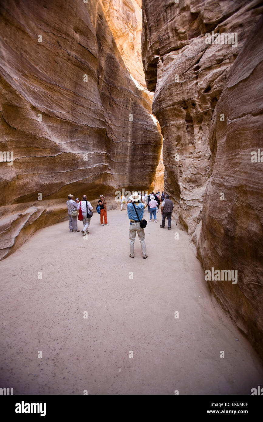 Visitors approach Petra through a narrow and dramatic 1.2 km long ...