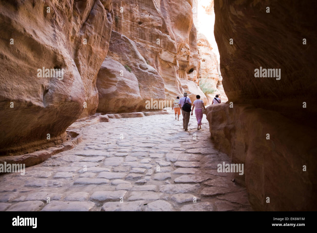Visitors approach Petra through a narrow and dramatic 1.2 km long ...