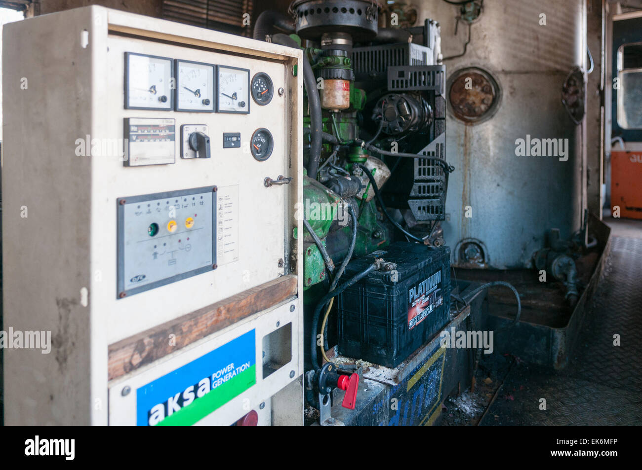 Old diesel engine powering an electric generator and control panel ...