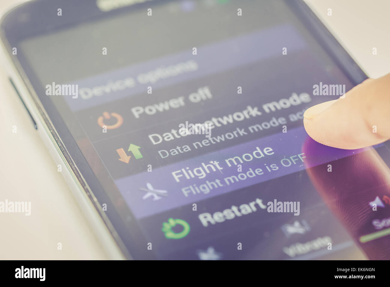 Close up finger press flight mode button on smartphone Stock Photo - Alamy