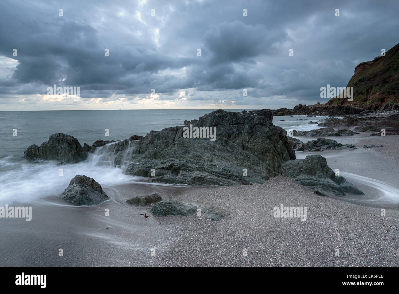 Grey cloudy skies over the beach at Portwrinkle on the Cornish ...