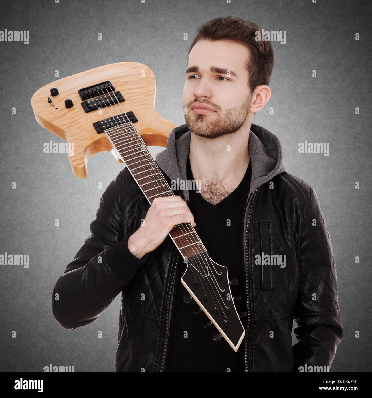 Handsome young man with an electric guitar Stock Photo - Alamy