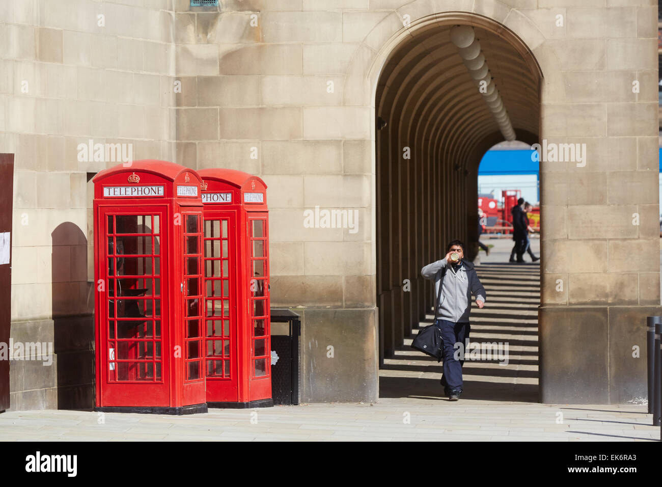 Manchester Town Hall extension arches walkway with red telephone boxes ...