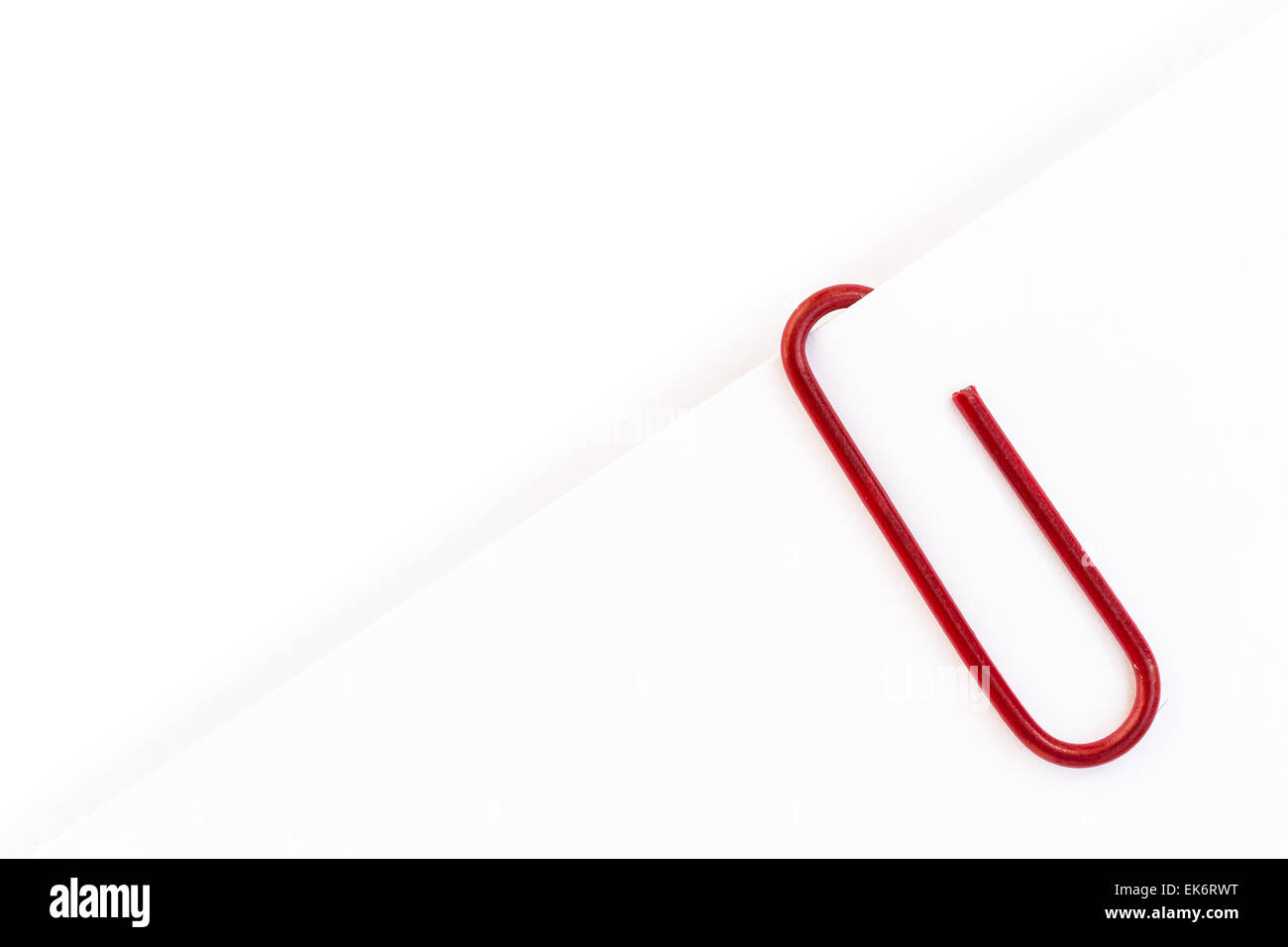 Red paper clip on white paper Stock Photo - Alamy