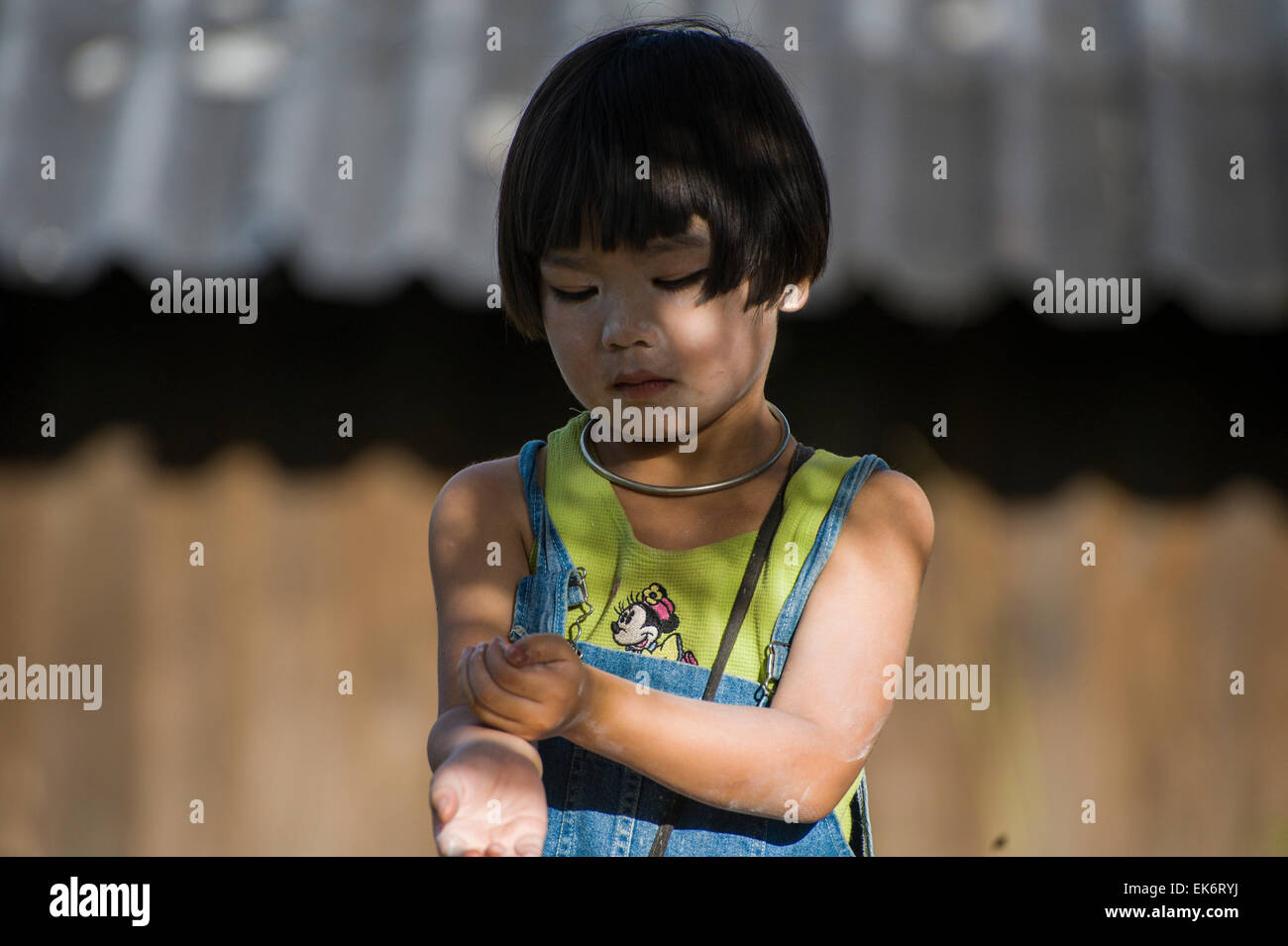 A Child applying chalk to her skin to be more white because in asia the ...