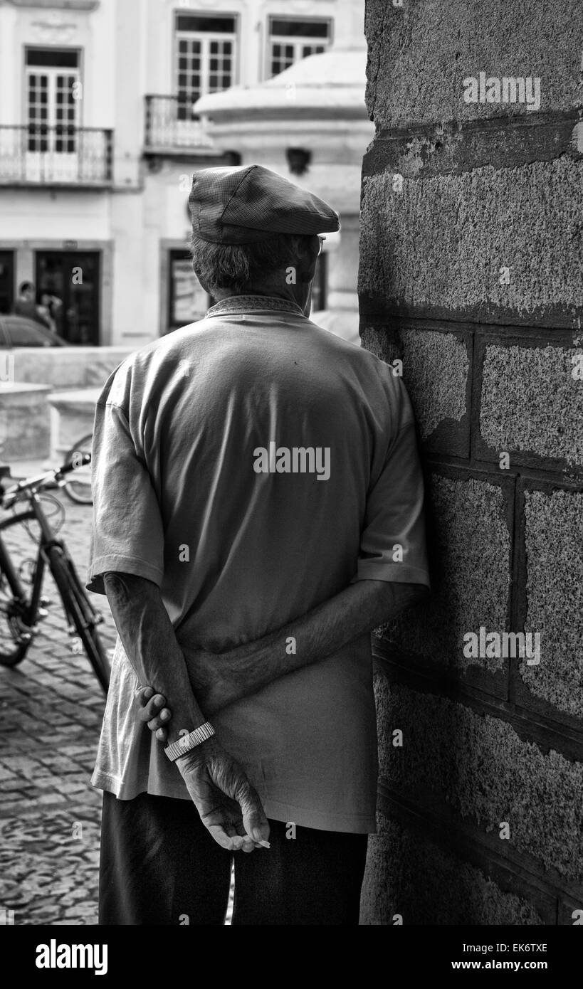 Leaning on pillar Black and White Stock Photos & Images - Alamy