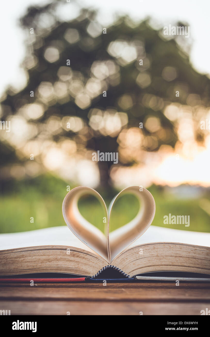 Close up book with heart symbol on table, retro color Stock Photo - Alamy