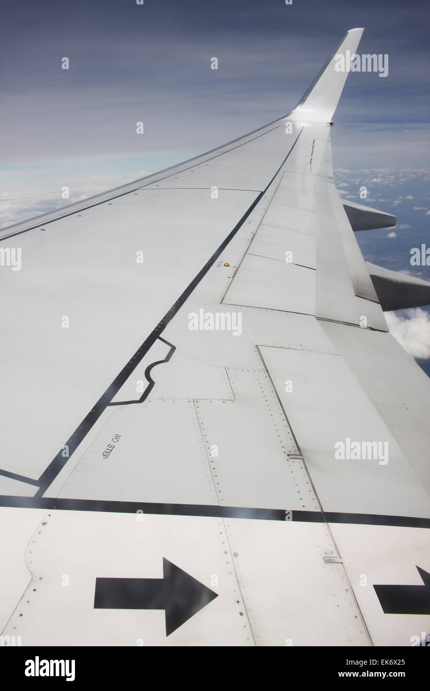 A right wing of Boeing 737-800 jet plane during flight on high altitude ...