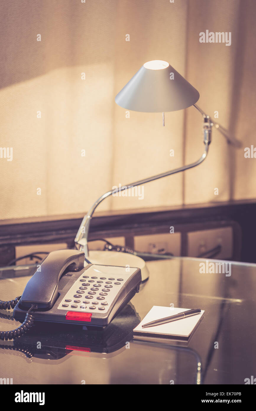 Telephone on glass table in hotel room Stock Photo - Alamy