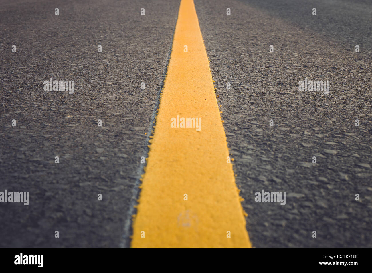 Asphalt road texture with yellow stripe Stock Photo - Alamy