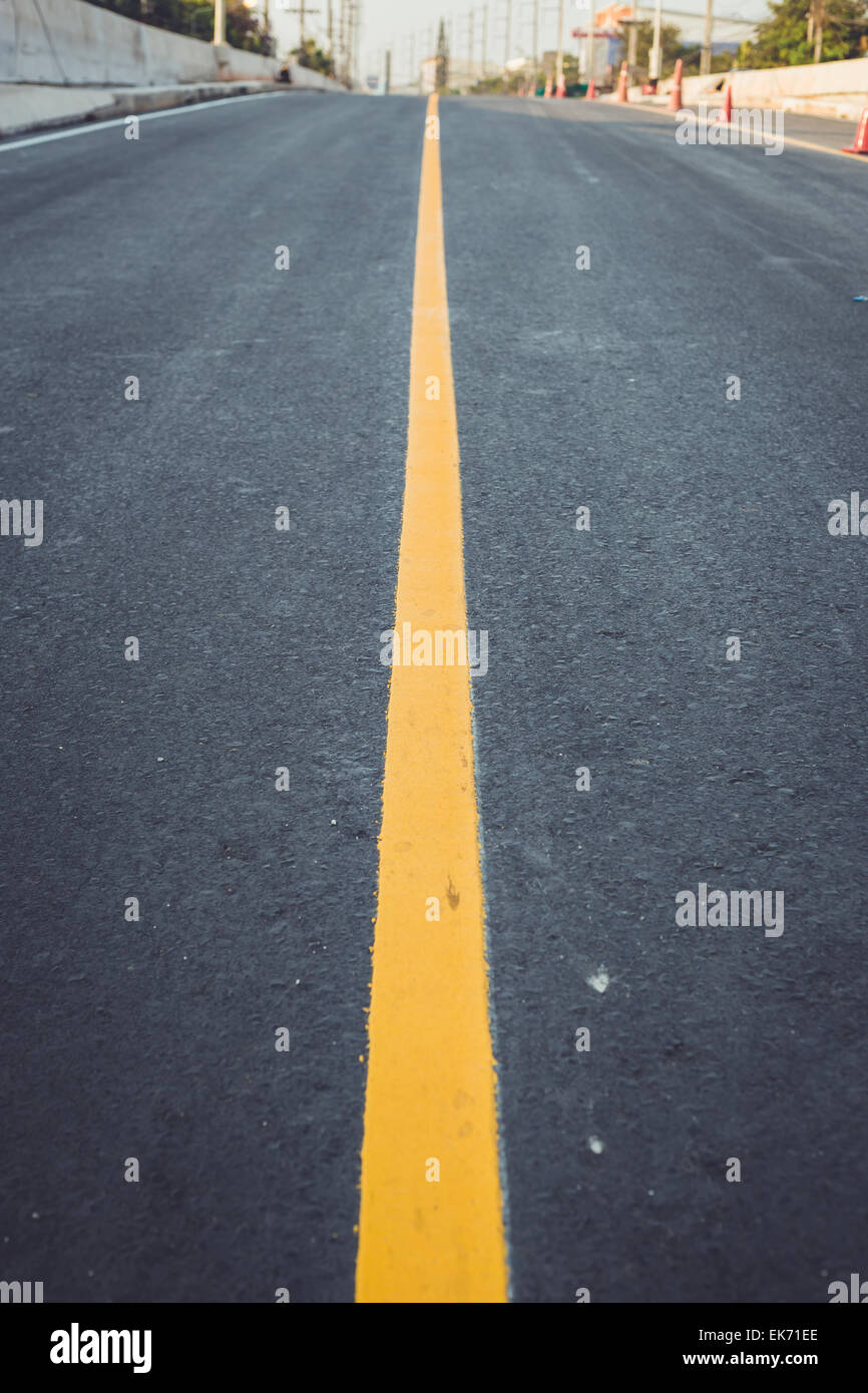 Asphalt road texture with yellow stripe Stock Photo - Alamy