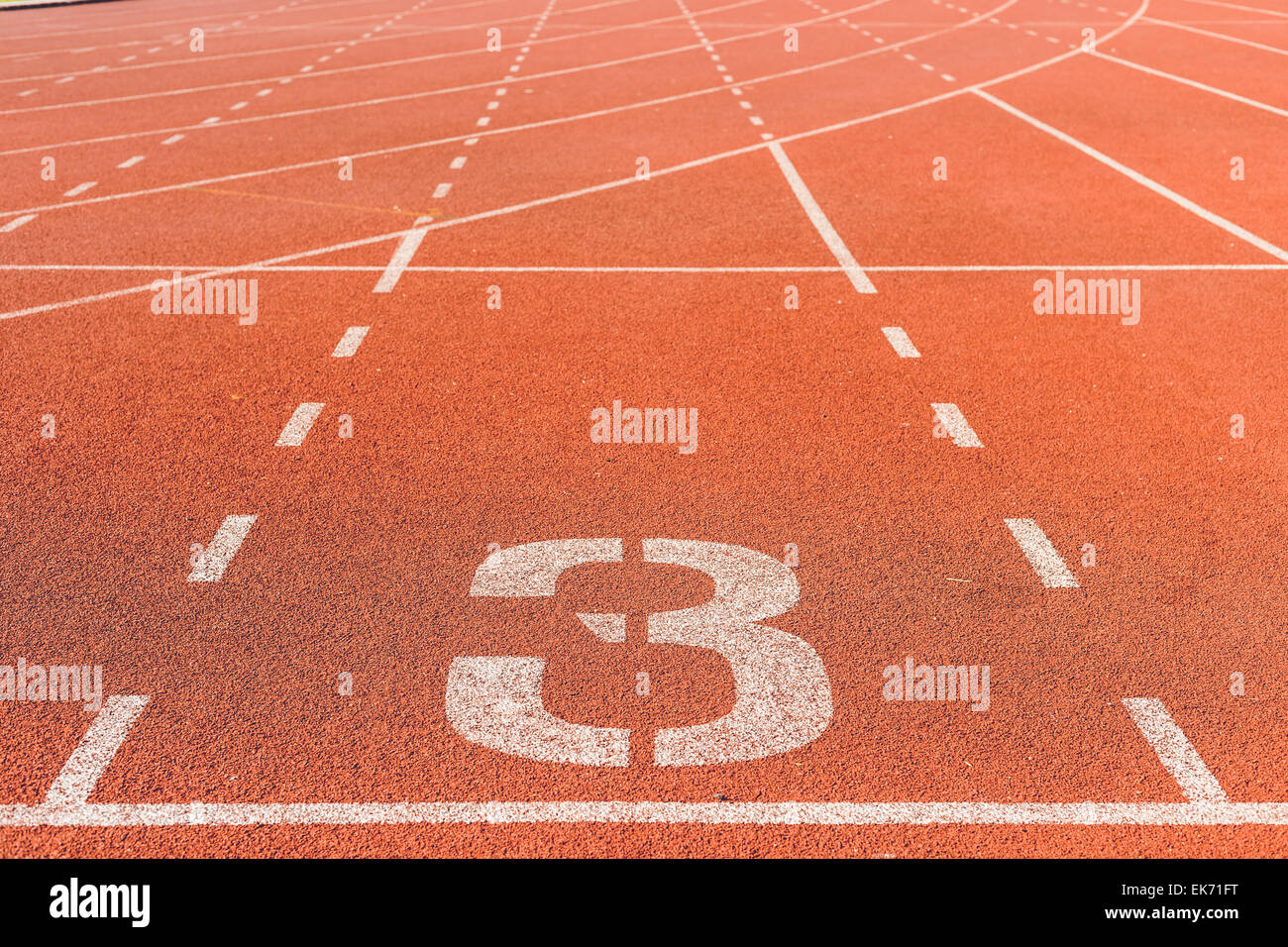 Running track with white number Stock Photo - Alamy