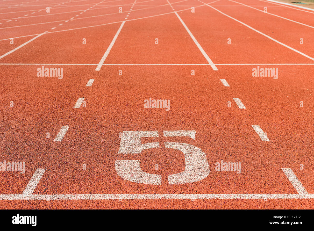 Running track with white number Stock Photo - Alamy