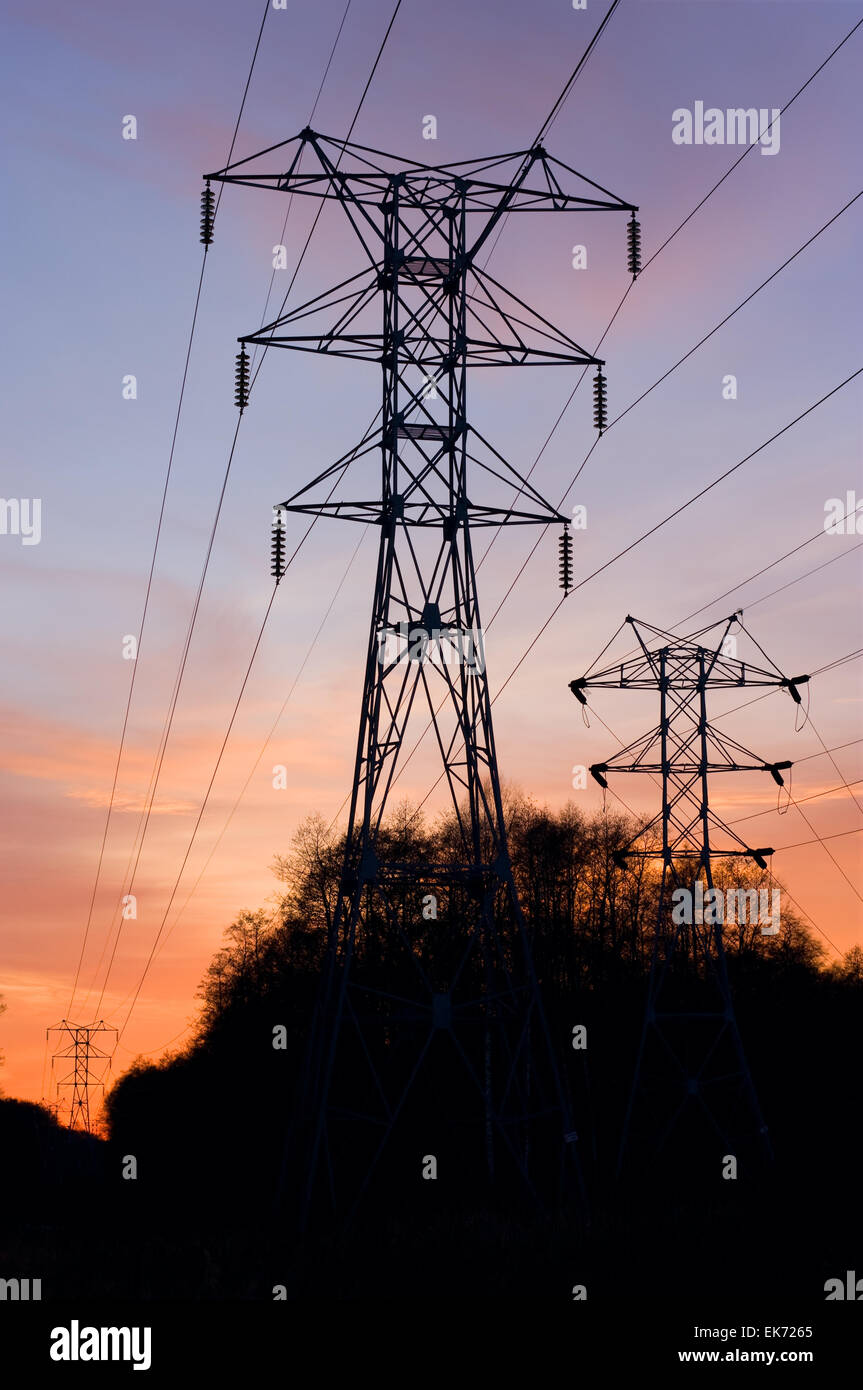 Silhouette of electric high voltage power line towers on a sunset Stock ...