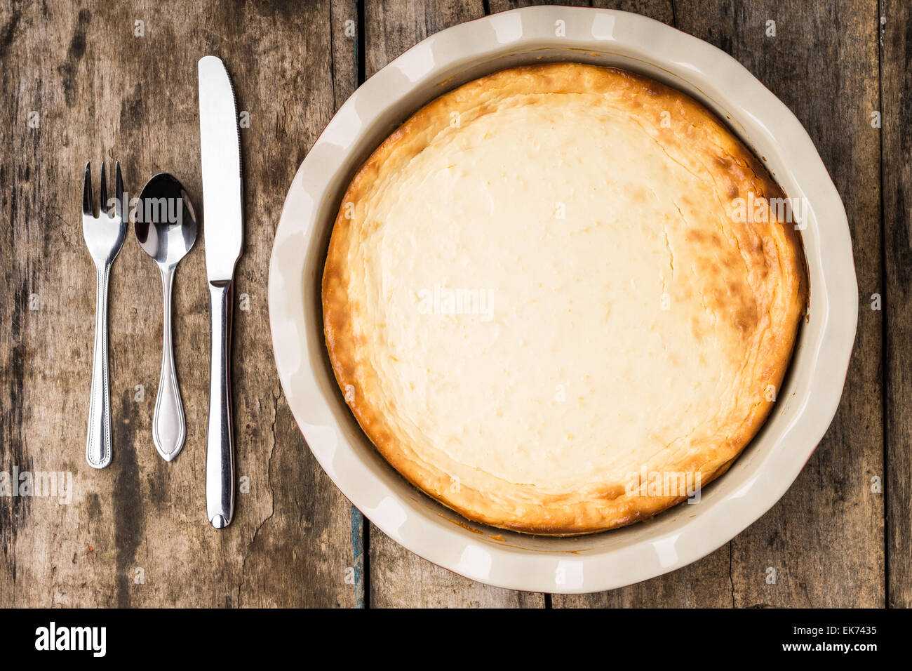 Fresh baked cheesecake on wooden table with silverware. Top view image ...