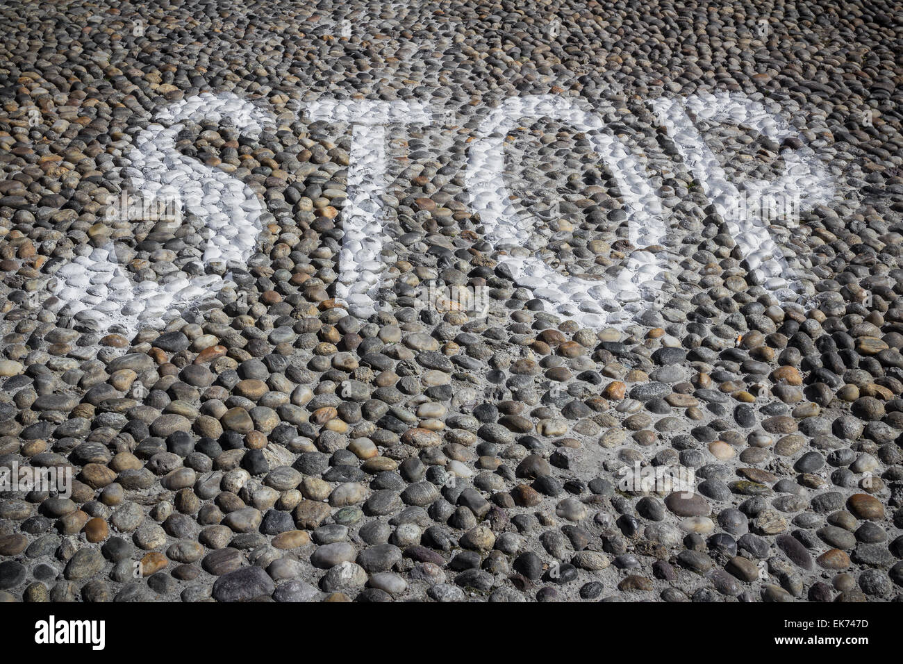 Detail of a paved road with stop sign Stock Photo - Alamy