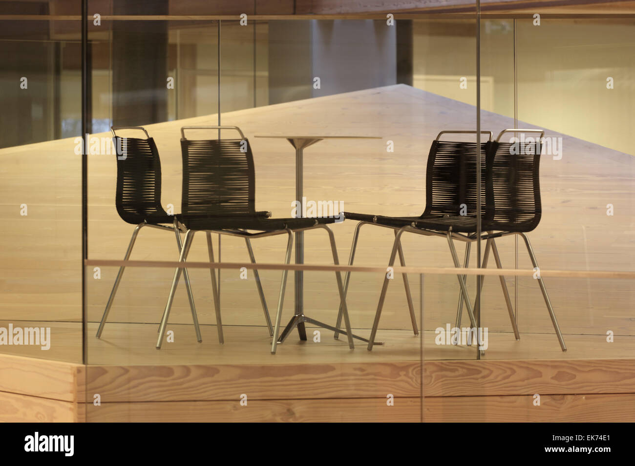 Meeting table and chairs on first floor with timber pyramid behind. IBC ...