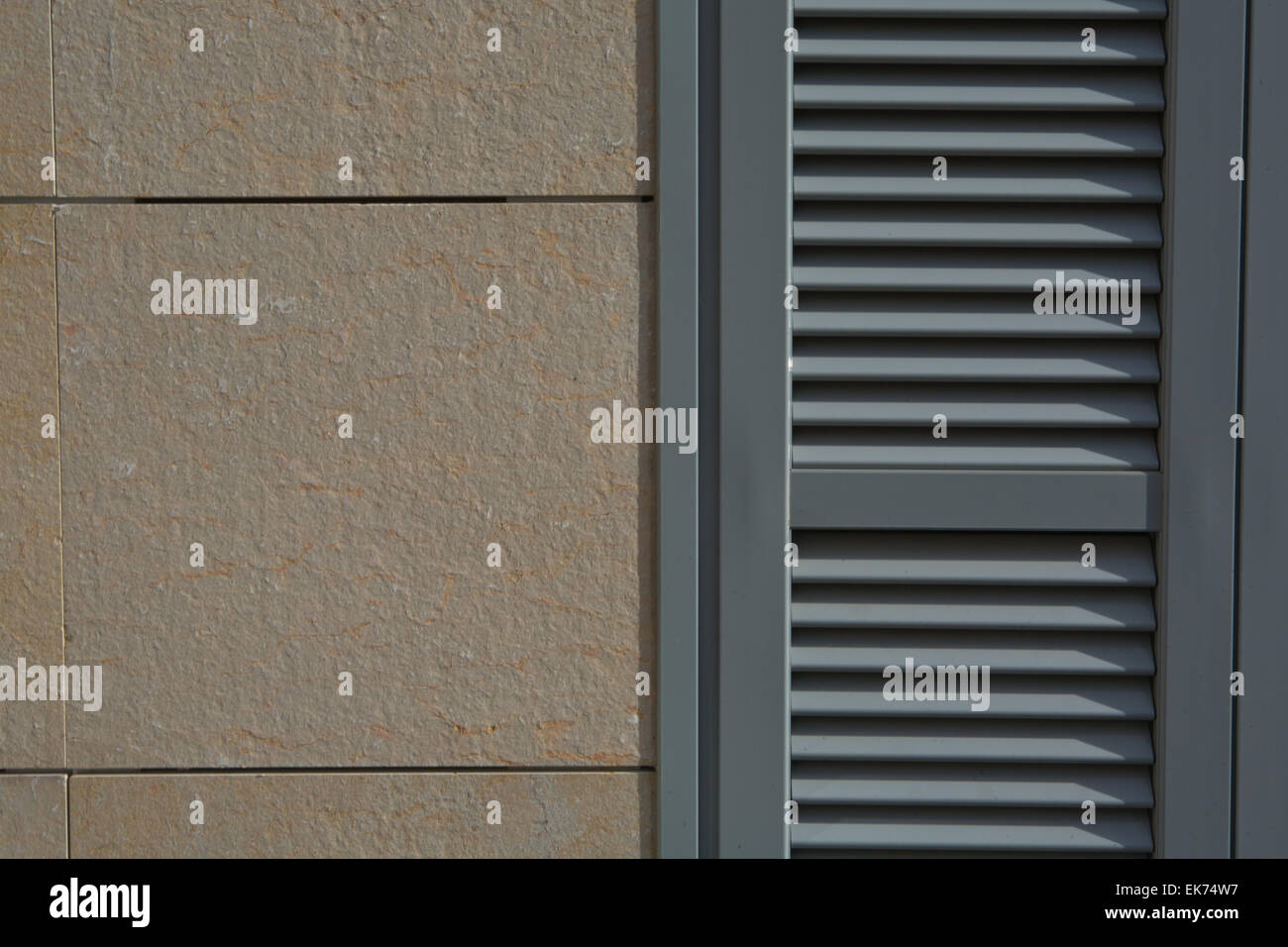 Metallic blue shutter over stone tiles wall background Stock Photo - Alamy