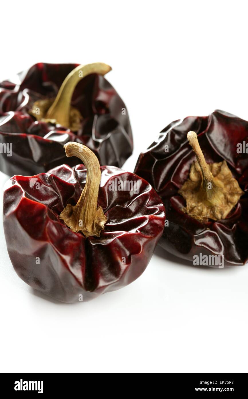 Three round Mediterranean dried dark red peppers Stock Photo - Alamy