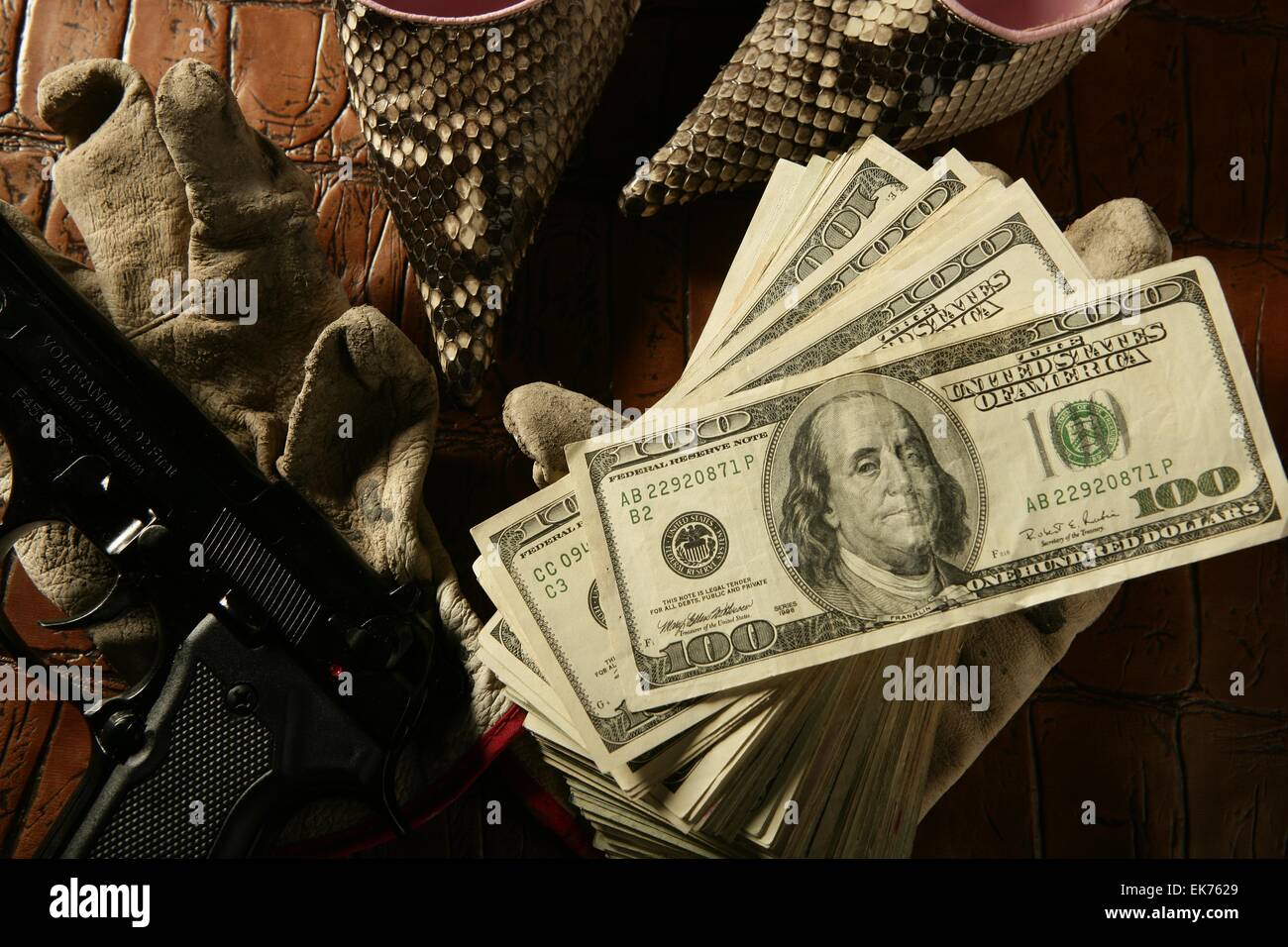 Dollar notes and gun, black pistol Stock Photo - Alamy