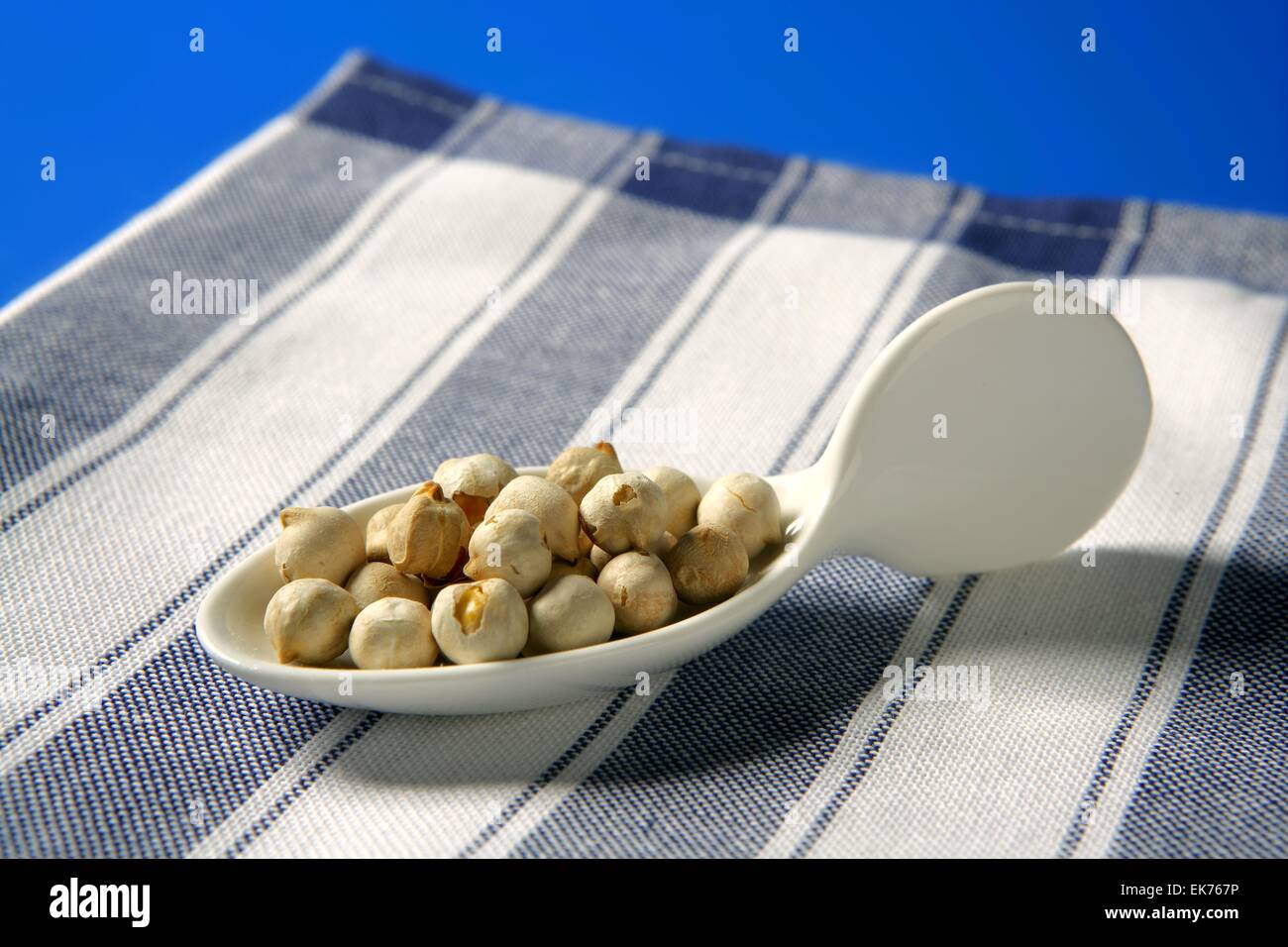 Chickpeas still spread over blue background Stock Photo - Alamy