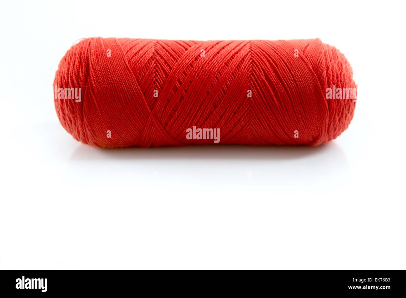 Red thread spool isolated over white Stock Photo - Alamy