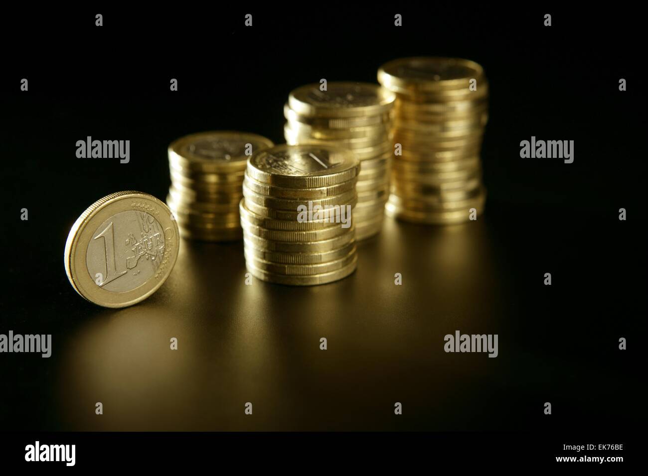 Euro currency coin columns with golden reflections Stock Photo - Alamy